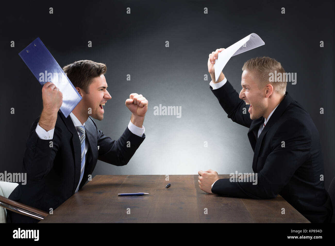 Aggressive Young Businessmen Arguing At Desk Stock Photo - Alamy