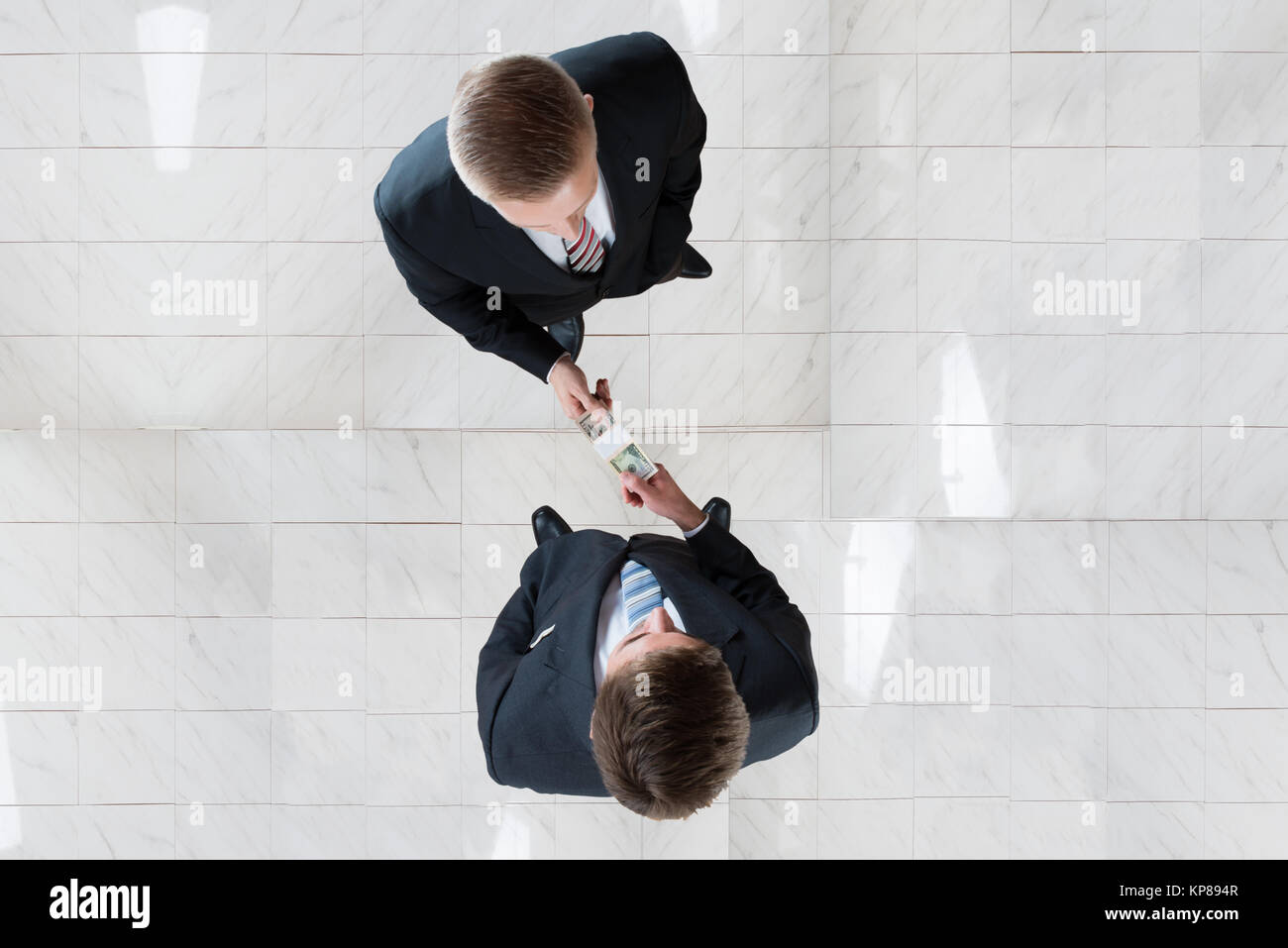 Businessman Bribing Colleague In Office Stock Photo - Alamy