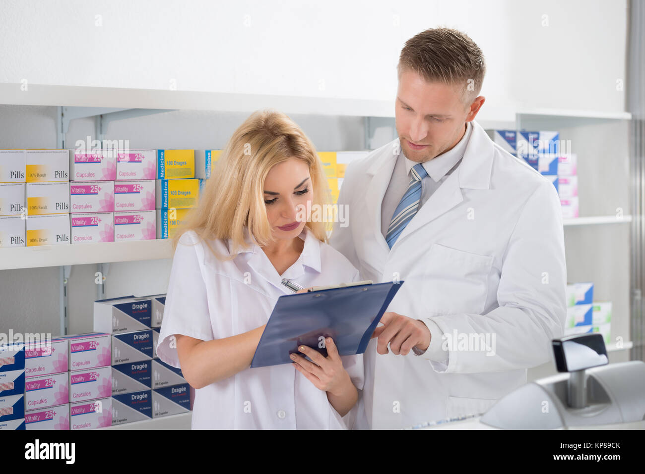 Pharmacists Maintaining Checklist In Pharmacy Stock Photo - Alamy