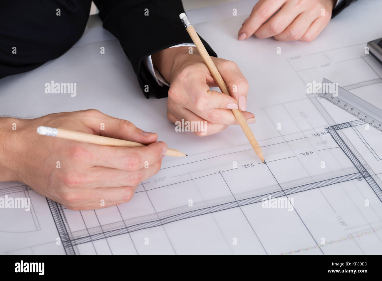 Business People Discussing A Architectural Drawing Stock Photo - Alamy