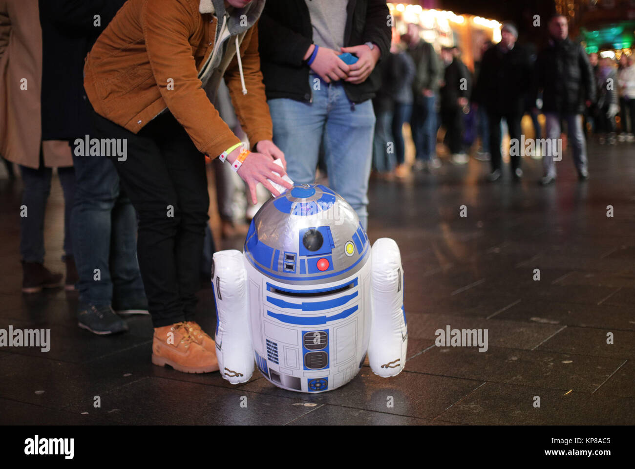 Fans with an inflatable R2-D2 arrive for a screening of Star Wars: The ...