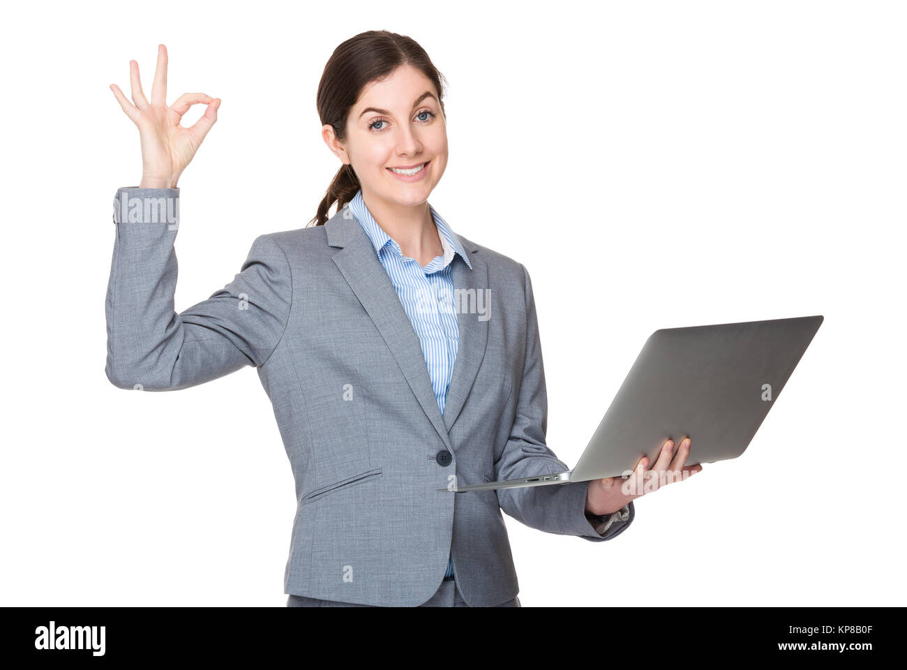 Young businesswoman hold with notebook computer and ok sign gesture Stock Photo - Alamy