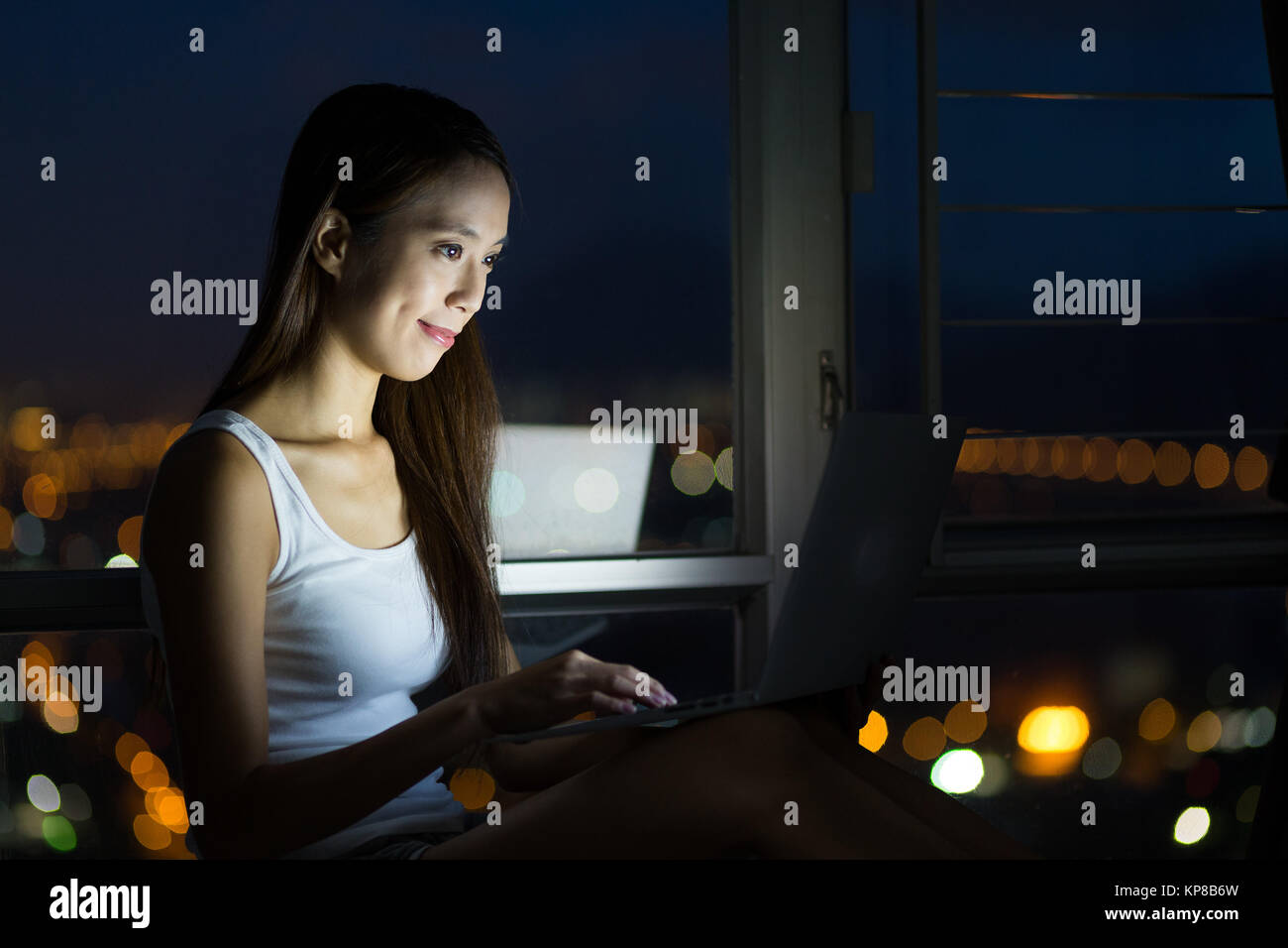 Woman use of the laptop computer at night Stock Photo - Alamy