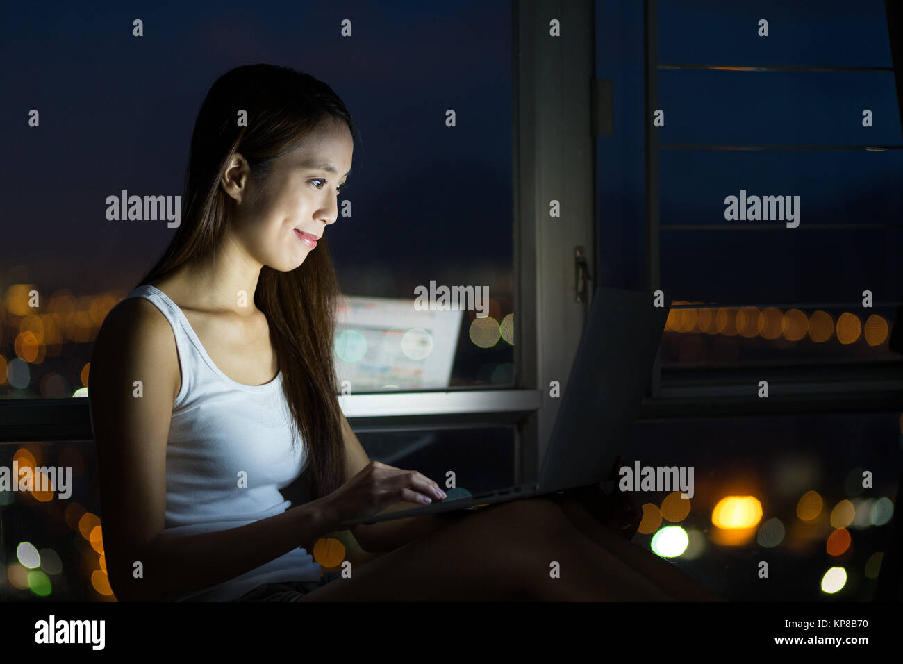 Woman working with laptop computer at night Stock Photo - Alamy