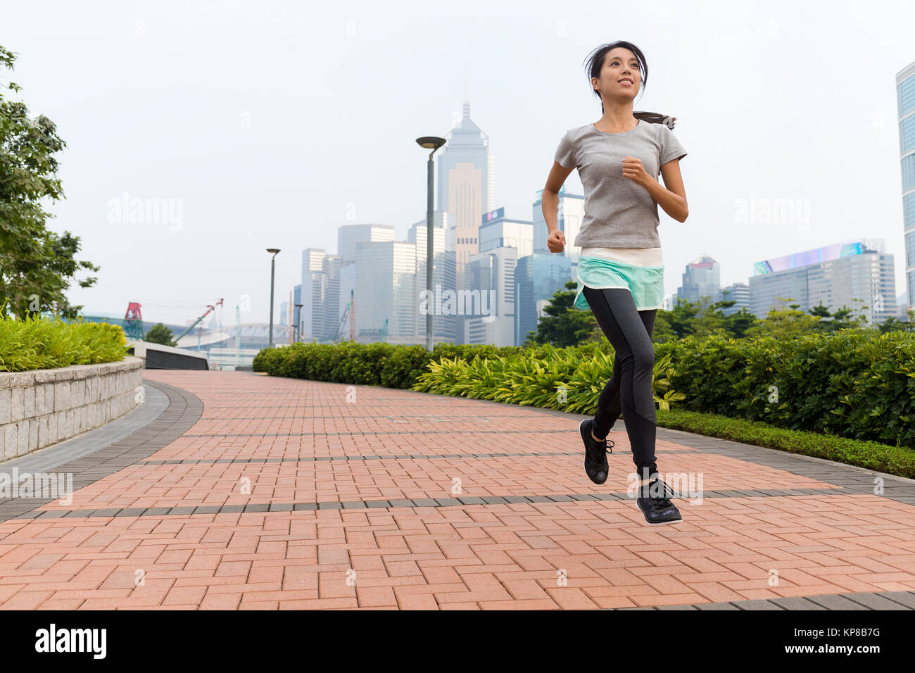Young Woman running in a city Stock Photo - Alamy