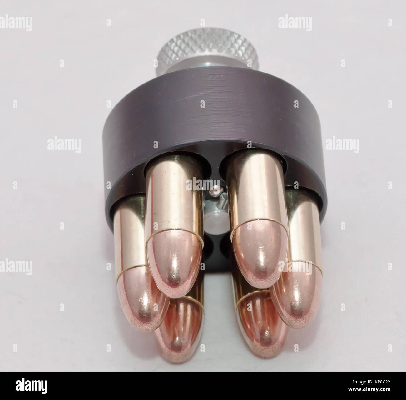 A loaded speed loader for a revolver on a white background Stock Photo ...