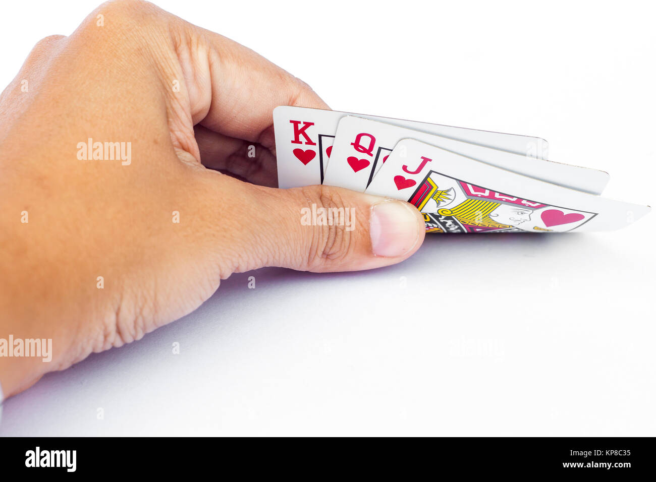 Playing cards in hand isolated on white background Stock Photo - Alamy