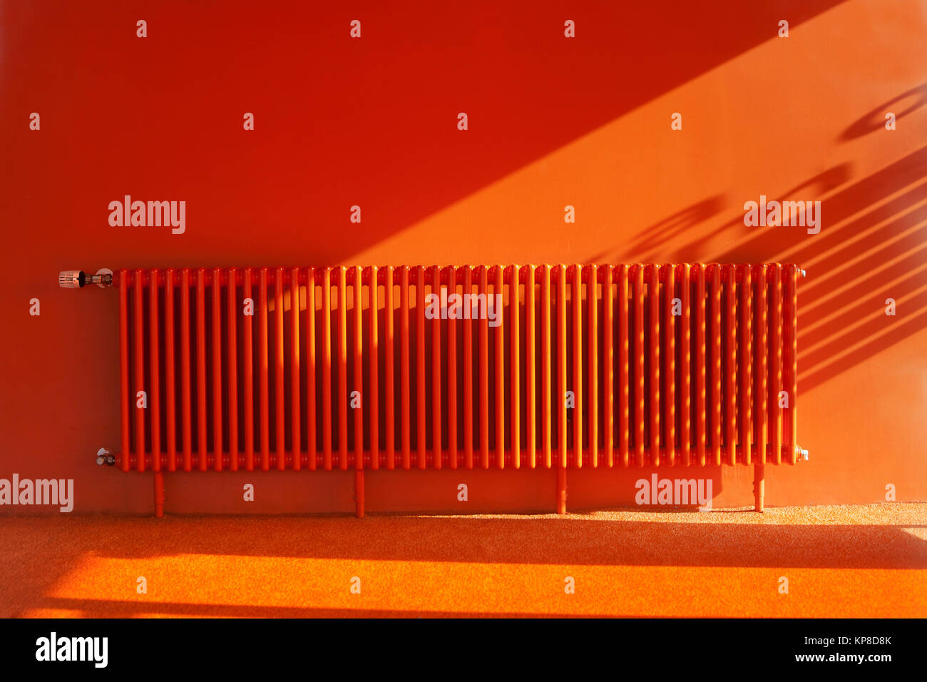 Orange radiator in a retro orange room Stock Photo - Alamy