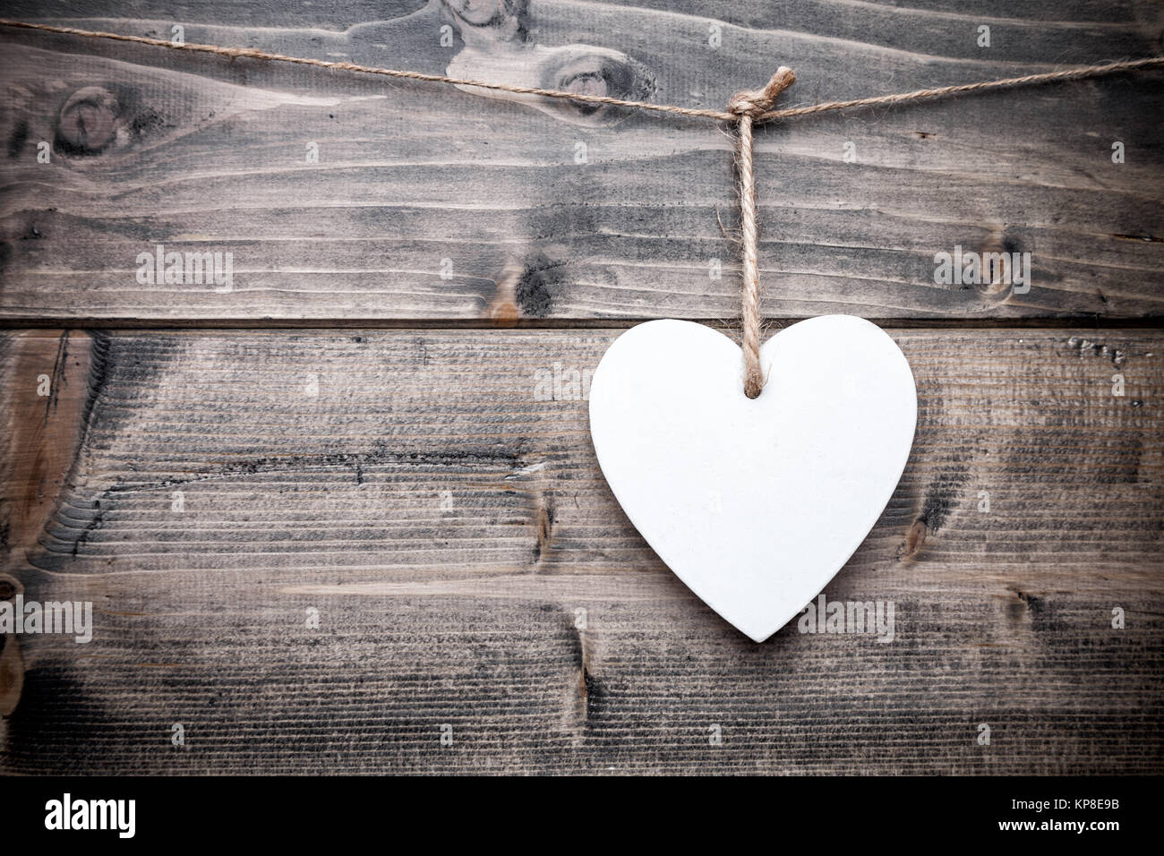 Love concept. Heart hanging on a string Stock Photo - Alamy