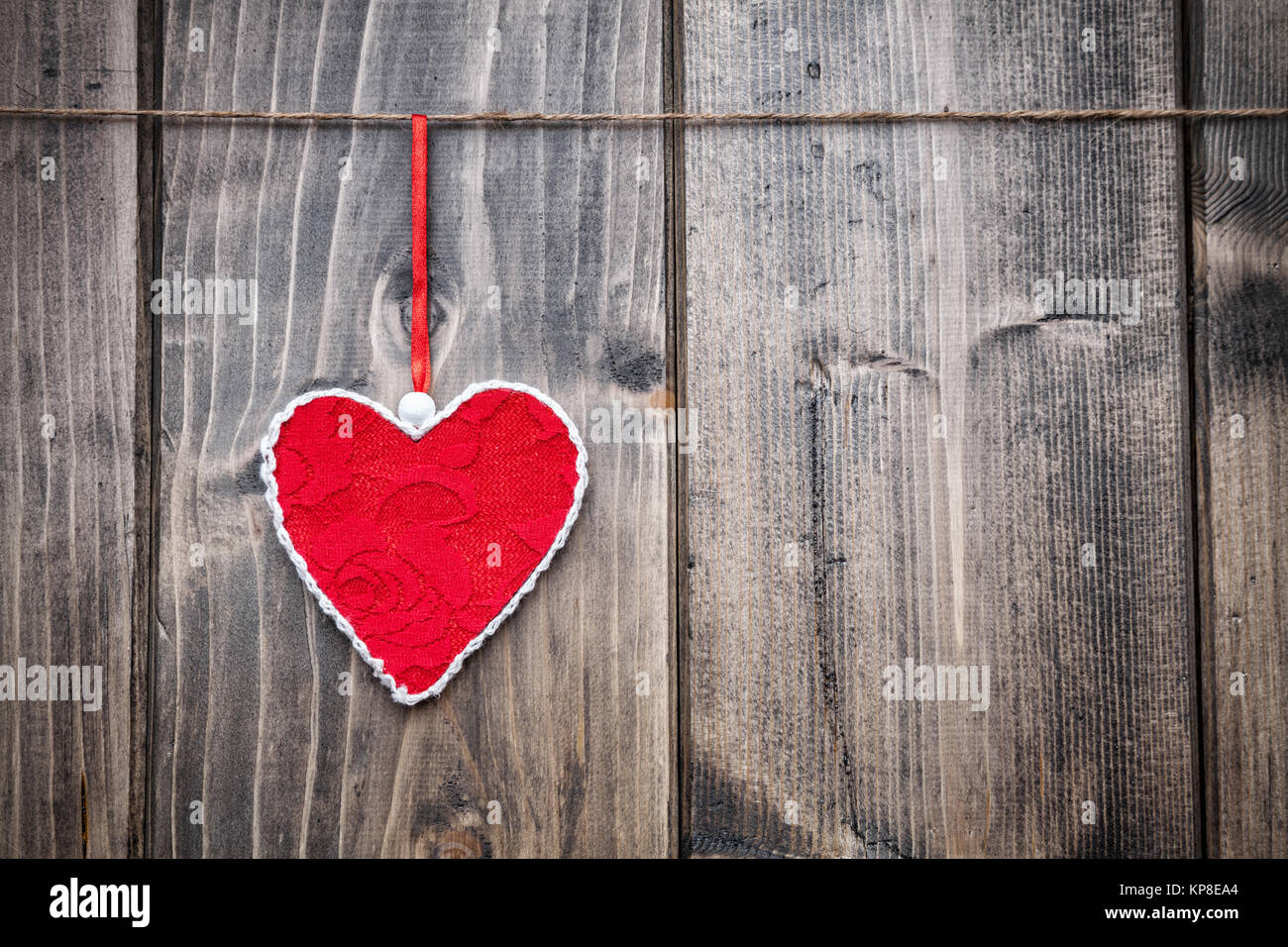 Love concept. Heart hanging on a string Stock Photo - Alamy