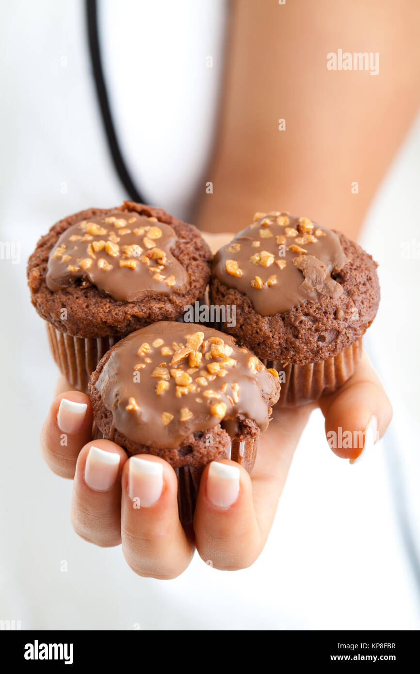 Chocolate muffins in womans hand Stock Photo - Alamy