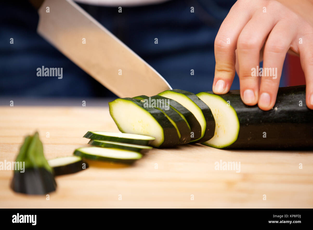 Young woman cutting zucchini,Young woman cutting zucchini,Young woman ...