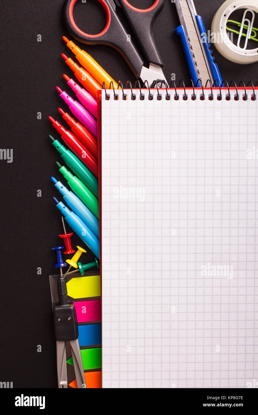 Office supplies with checkered notepad Stock Photo - Alamy