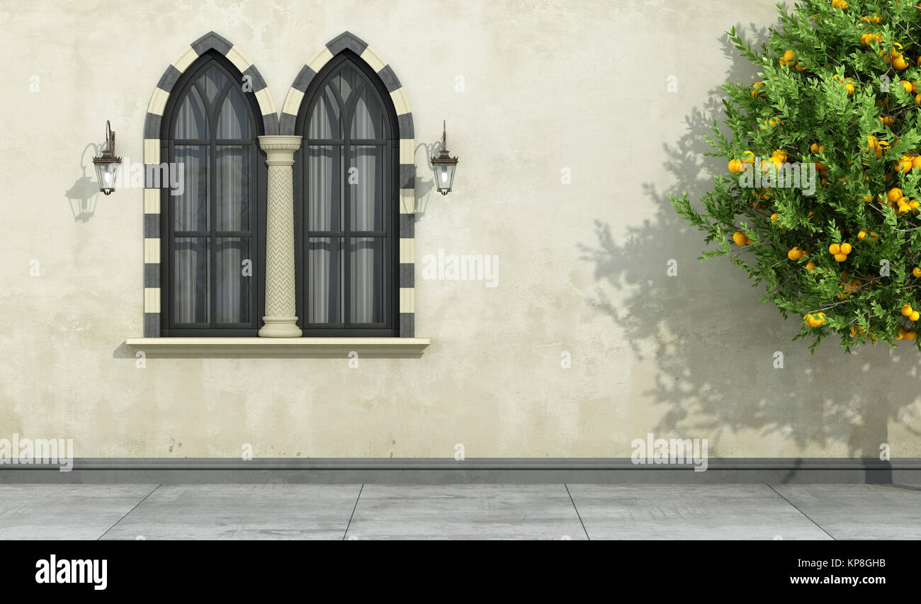 Old facade with mullioned gothic window Stock Photo - Alamy