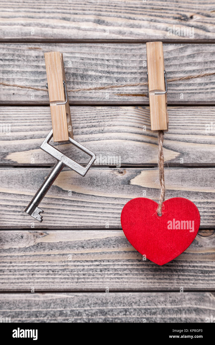 Heart and key hanging on a string Stock Photo - Alamy