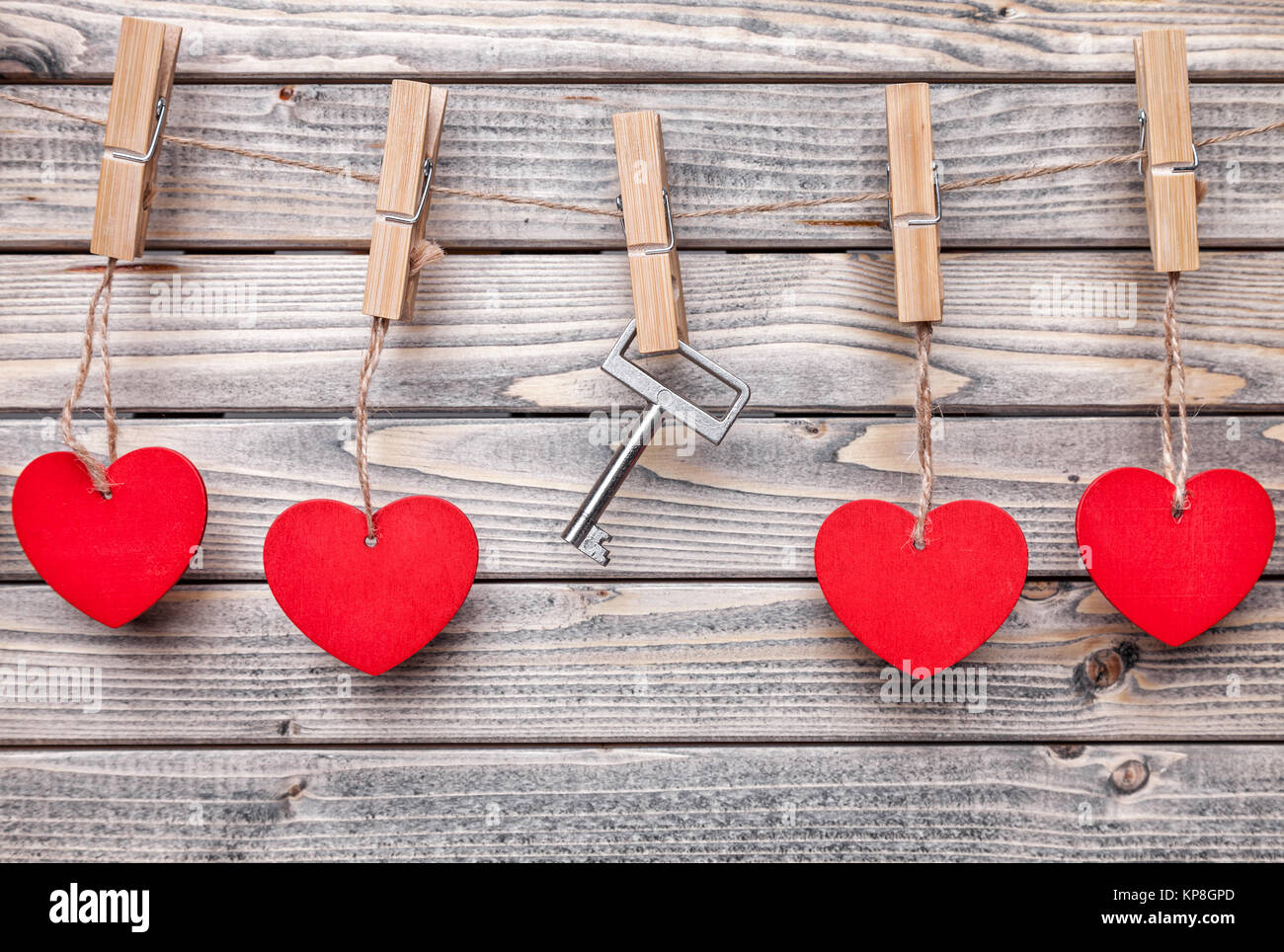 Hearts and key hanging on a string Stock Photo - Alamy