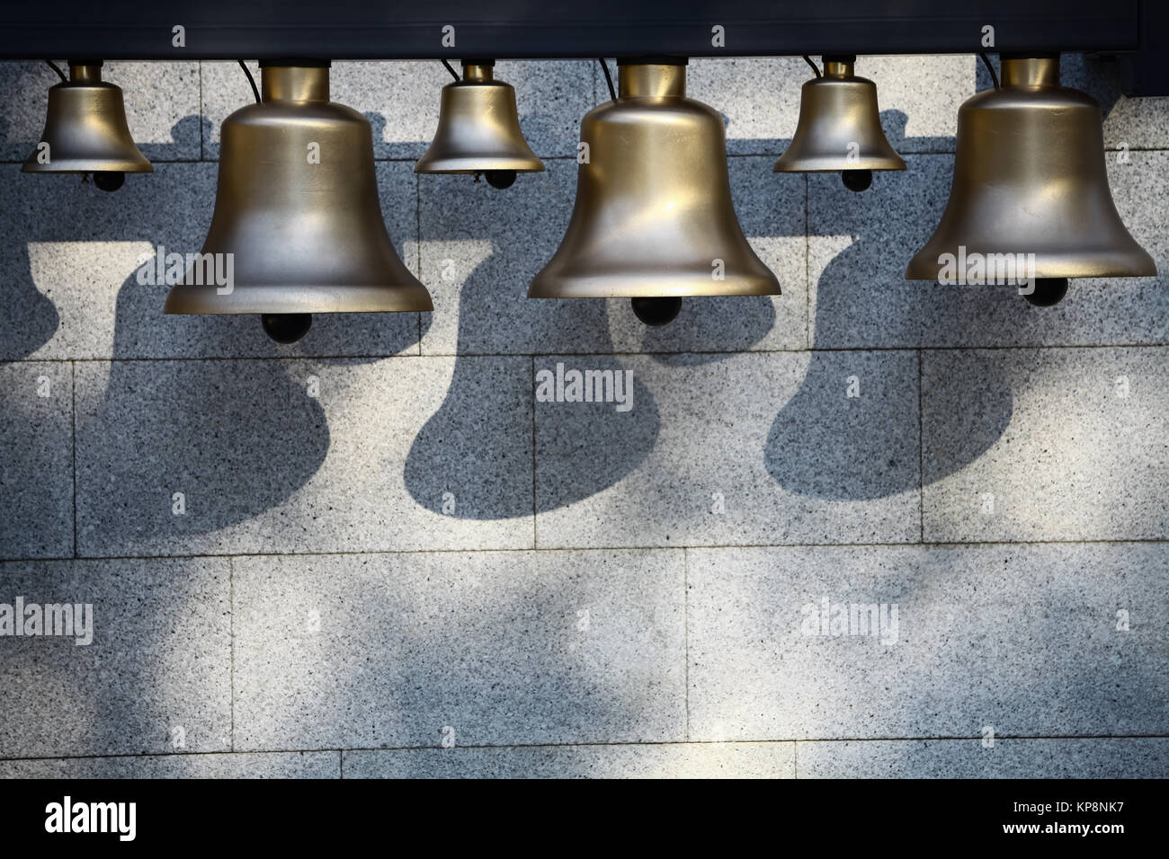 Various bells in a row Stock Photo - Alamy