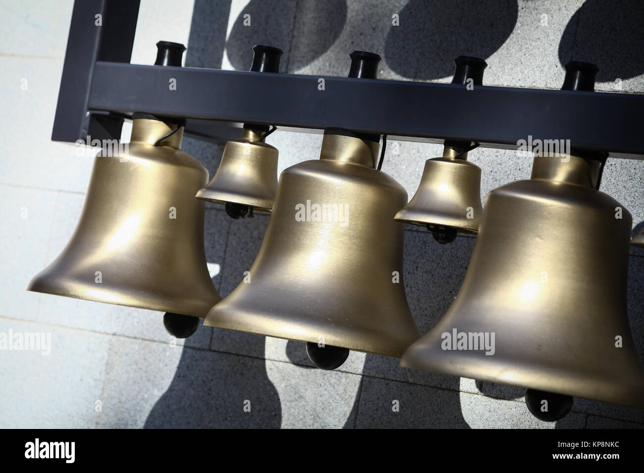 Various bells in a row Stock Photo - Alamy