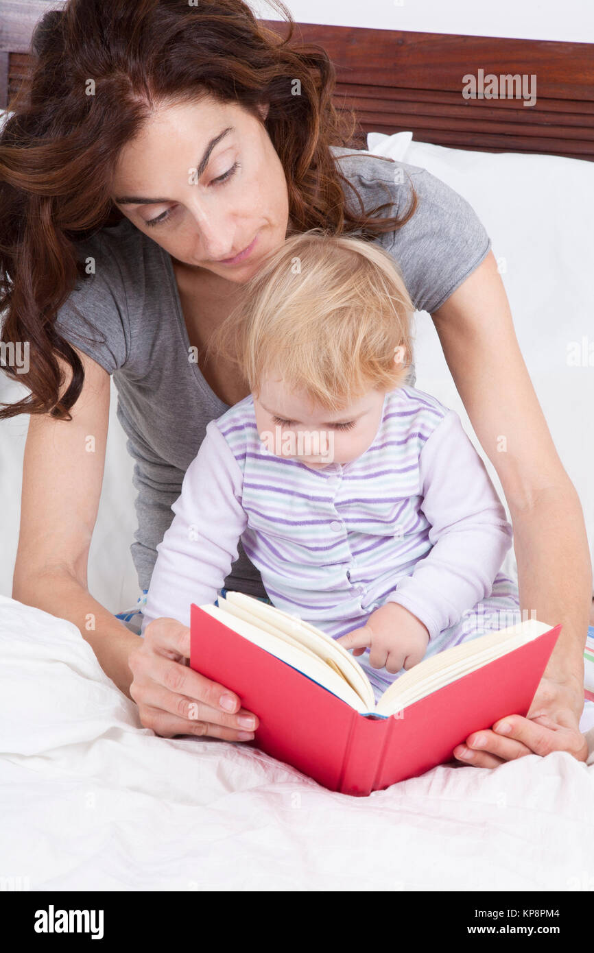 Mom reading book in bed hi-res stock photography and images - Alamy