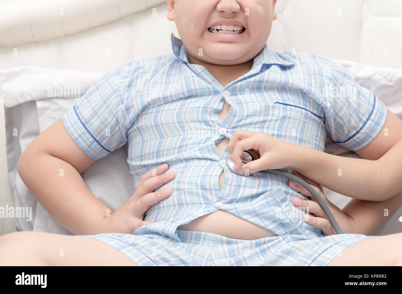 Little hand doctor check stomach by stethoscope to obese asian boy ...
