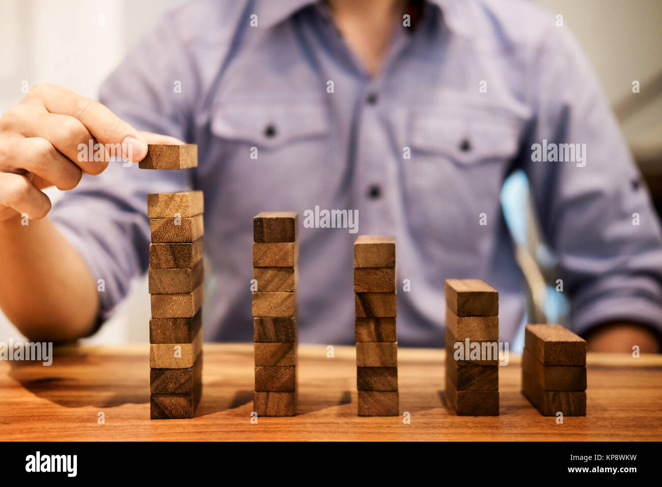 Business man hand put wooden blocks arranging stacking for development ...