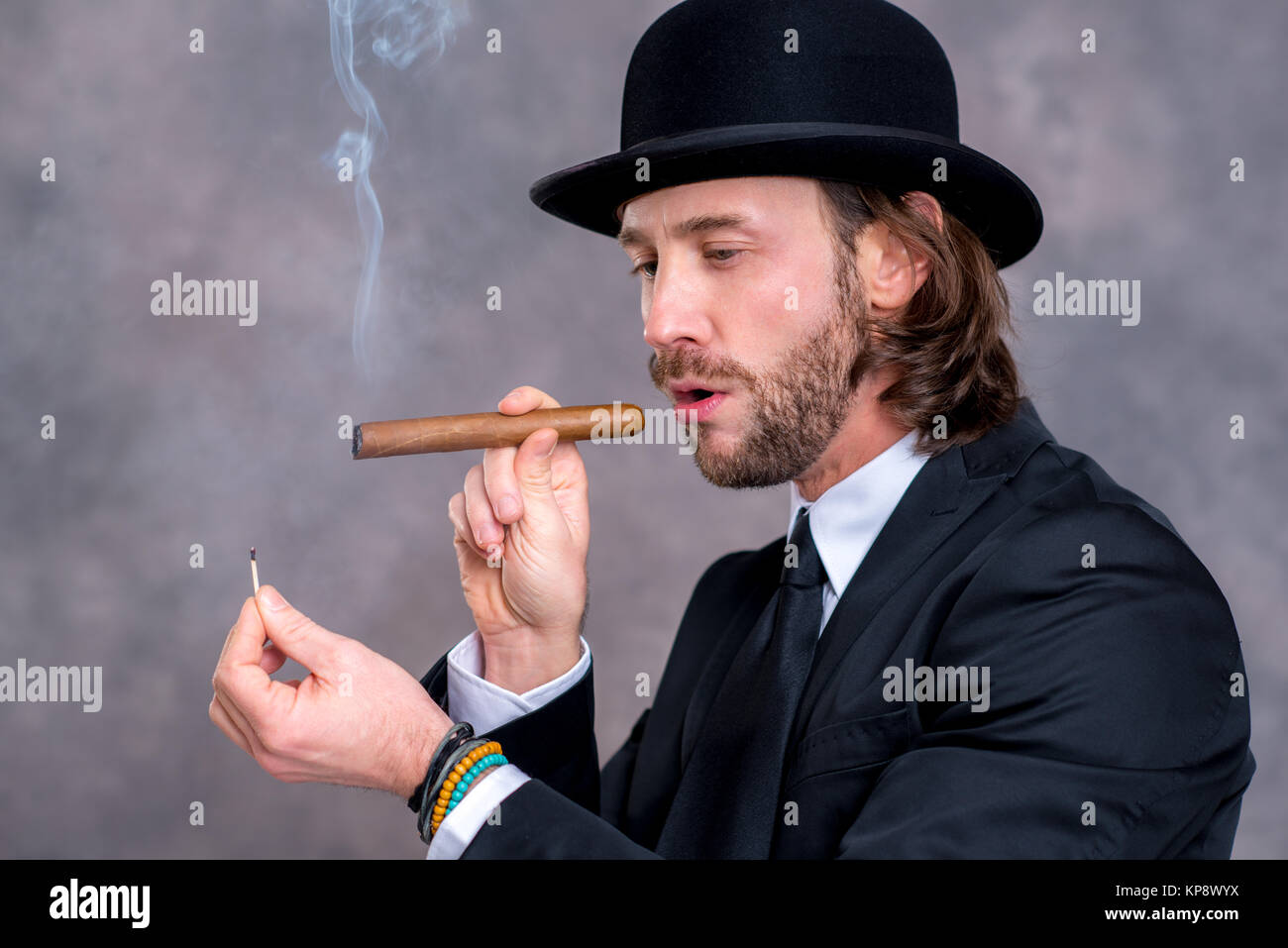 young businessman with bowler hat in black suit smoking big cigar Stock ...