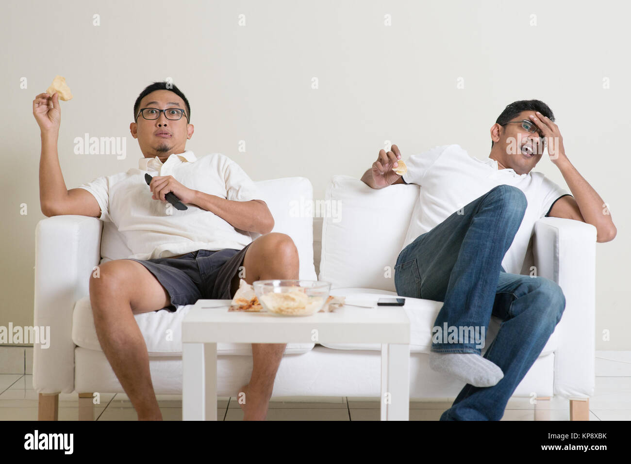 Men watching sport game on tv at home Stock Photo - Alamy