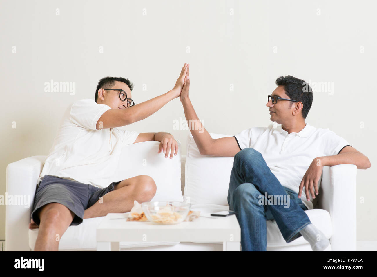 Men high five Stock Photo - Alamy