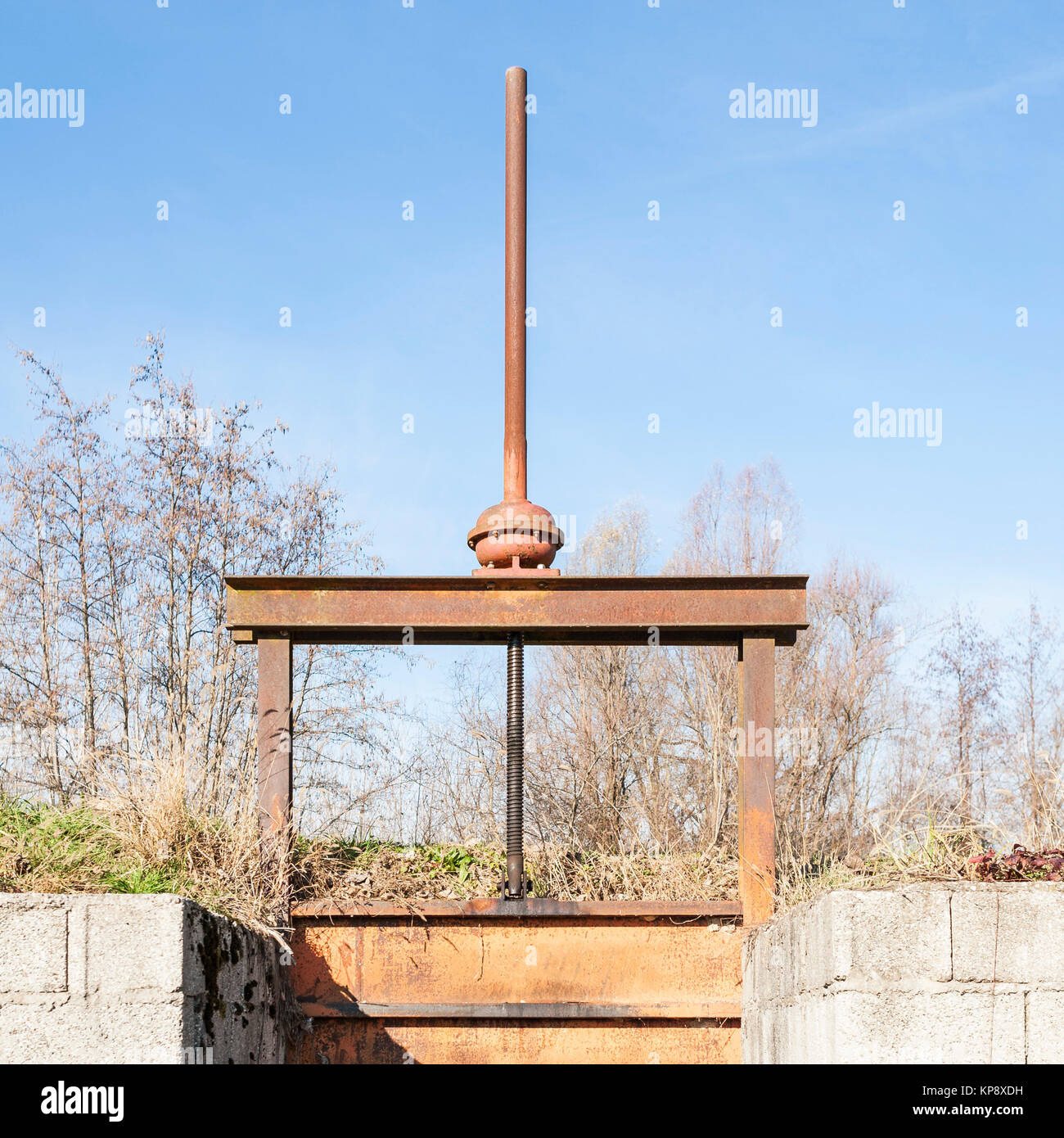 Irrigation Canal and old and manual Flood gate valve Stock Photo - Alamy