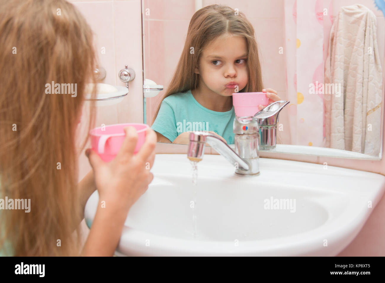 Child brushing teeth glass water hi-res stock photography and images ...