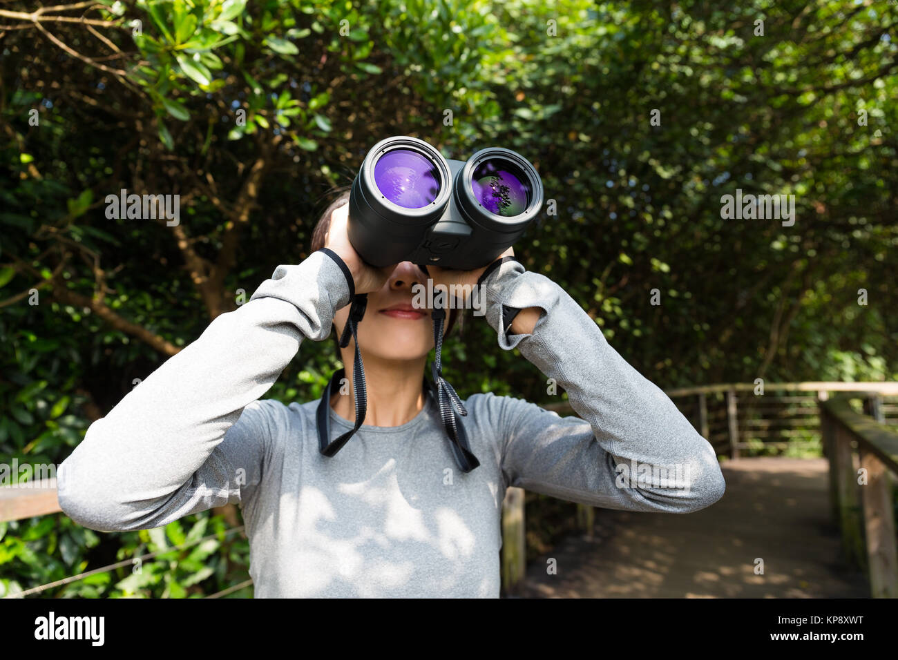 Asian woman use of the binoculars Stock Photo - Alamy