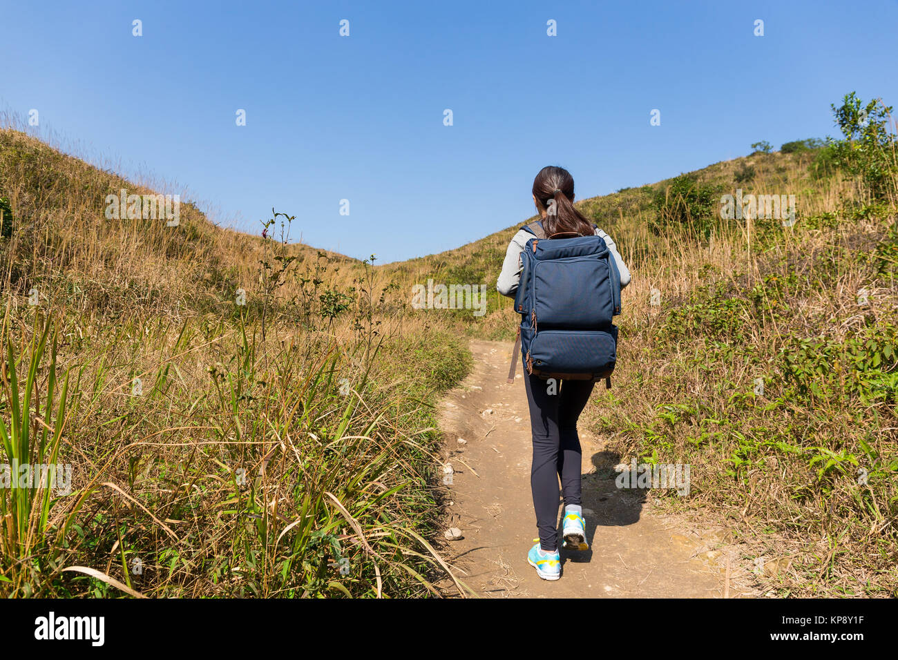 The back view of Woman go hiking Stock Photo - Alamy