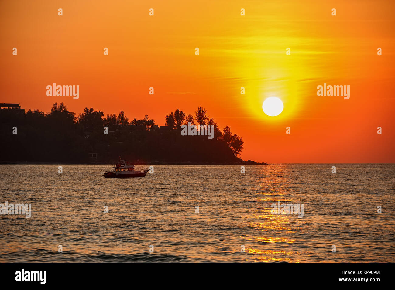 Beautiful sunset on a tropical beach. The ship sails in the last rays ...