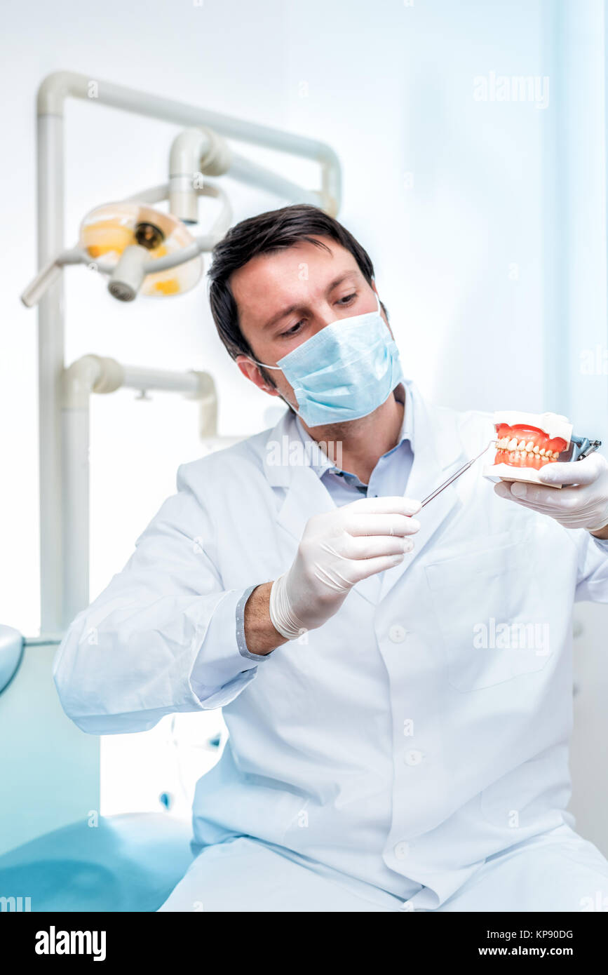 cheerful dentist presenting the denture Stock Photo - Alamy