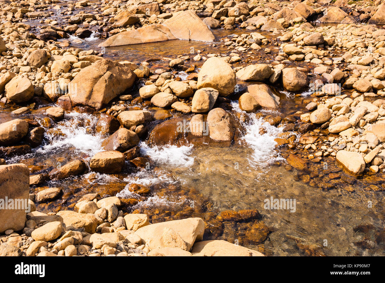 Clear shallow water flowing and splashing on bare rocks Stock Photo - Alamy