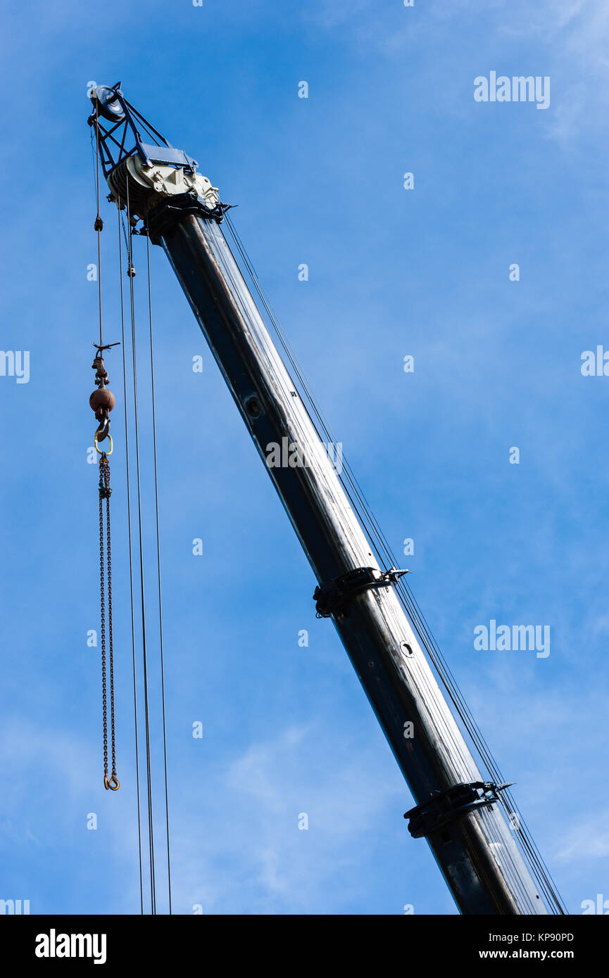 Large heavy industrial crane extended with pulleys and hanging cables ...
