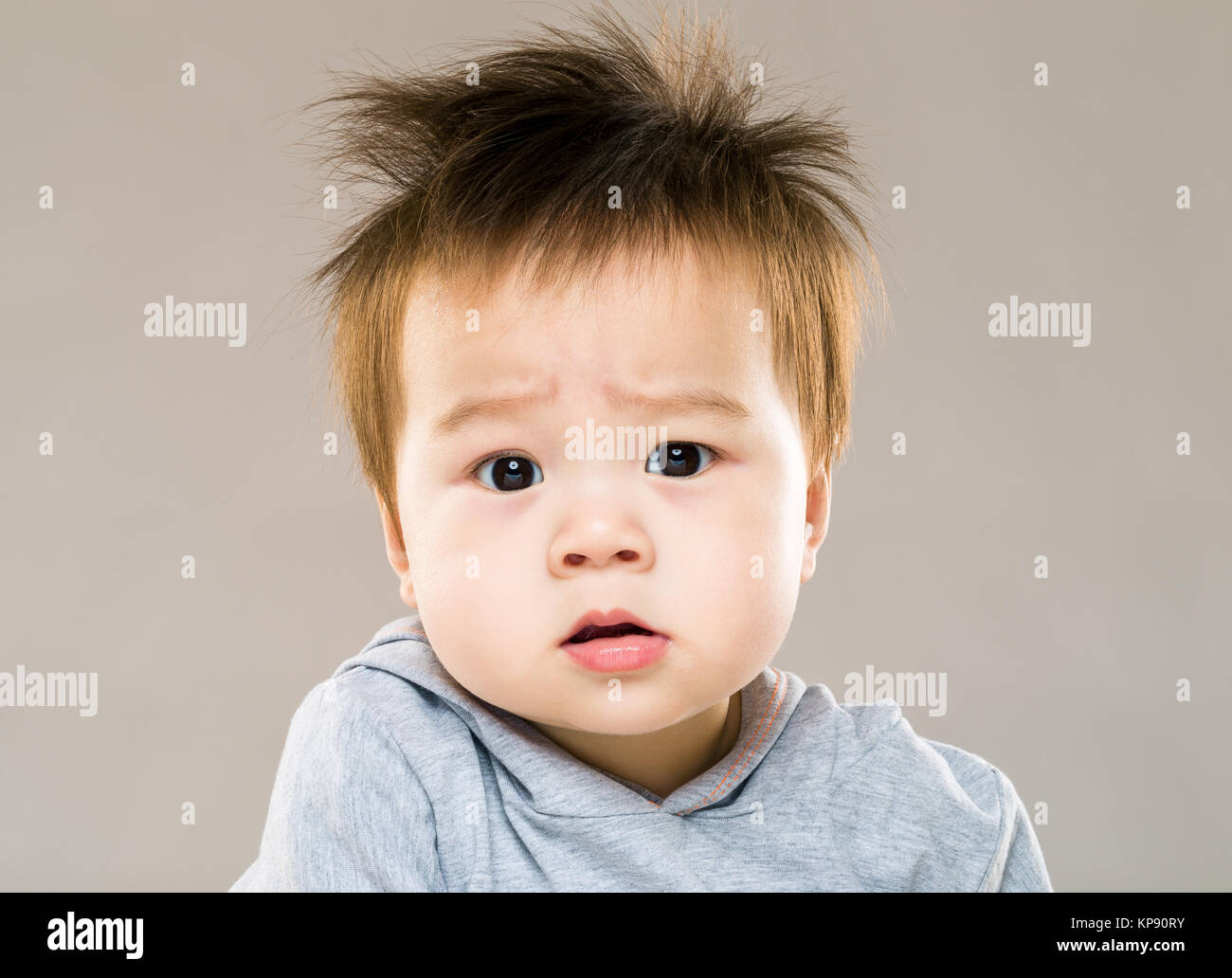 Serious baby boy Stock Photo - Alamy