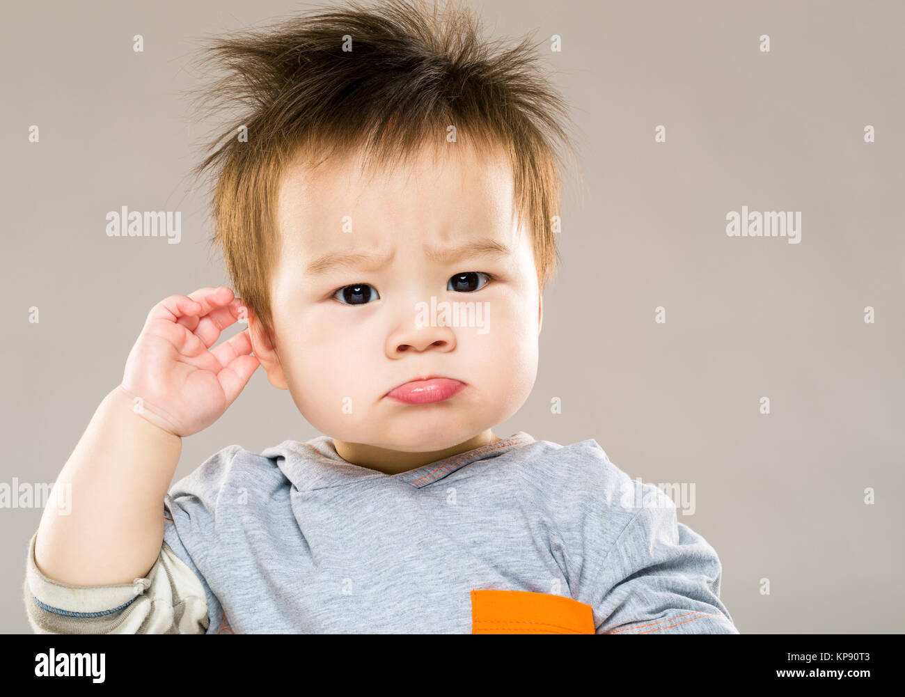 Confused baby boy hand touch ear Stock Photo: 168613987 - Alamy