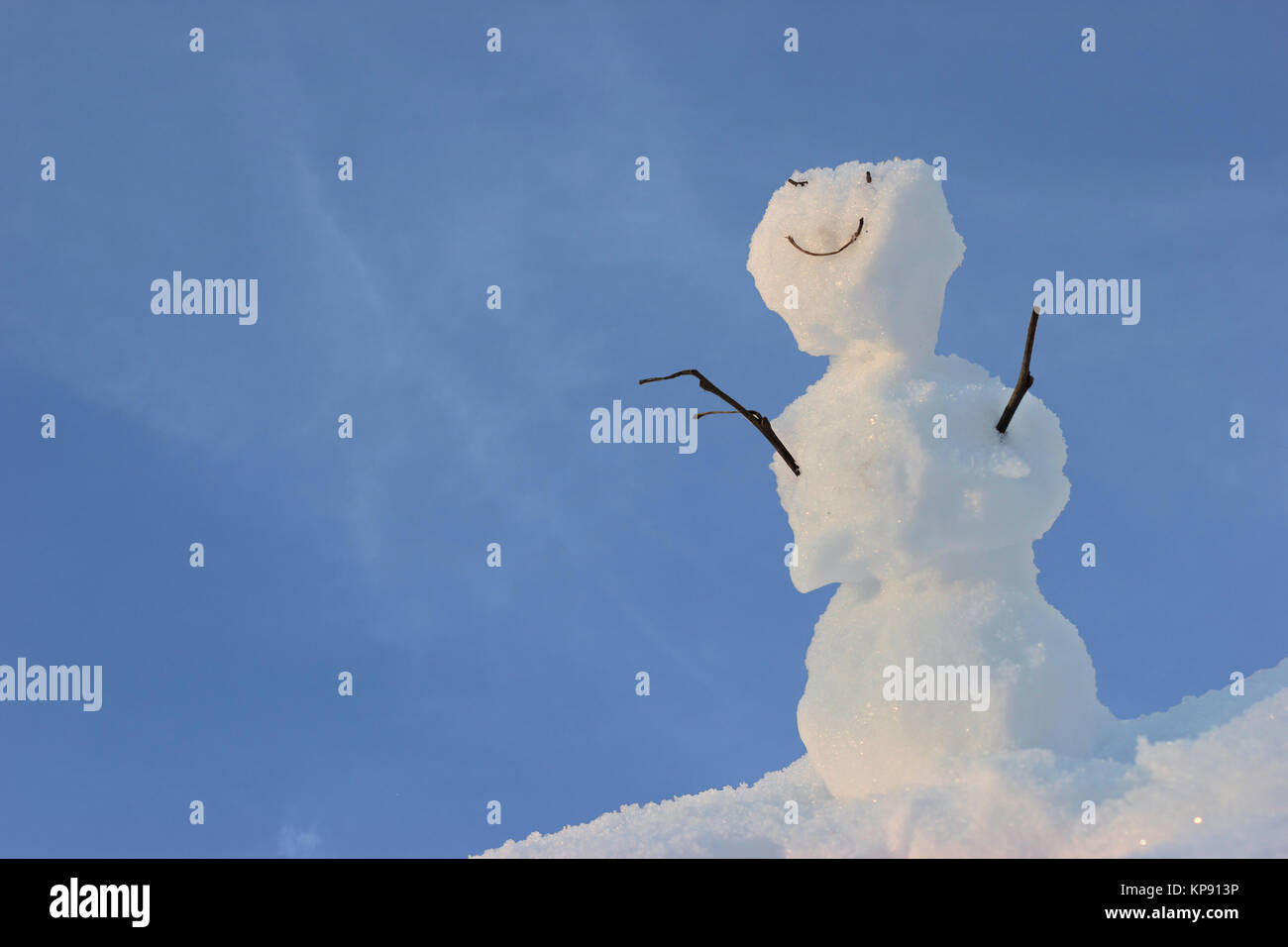 Friendly little snowman in front of blue sky Stock Photo - Alamy