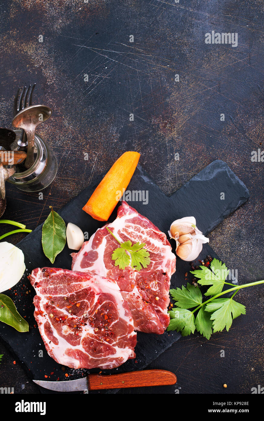 raw meat with salt and spice on a table Stock Photo - Alamy