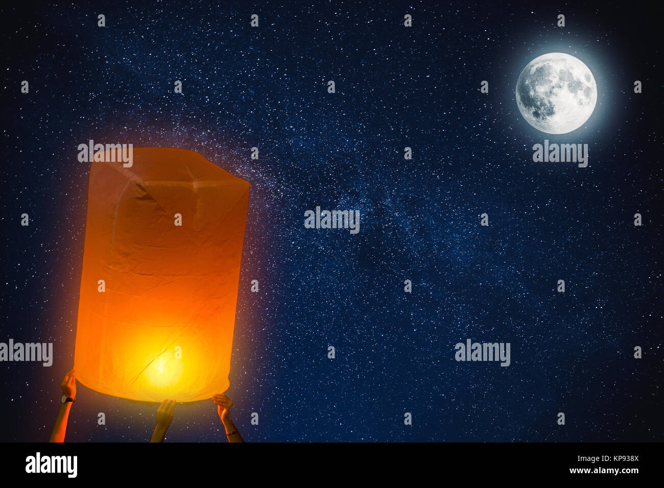 People Release Paper Fire Lamp rising over night sky full moon at Loy ...