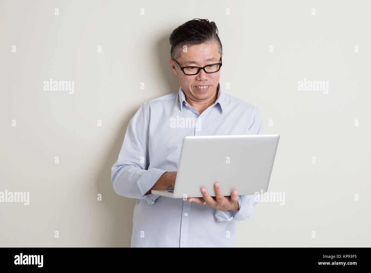 Mature Asian man and IT concept Stock Photo - Alamy