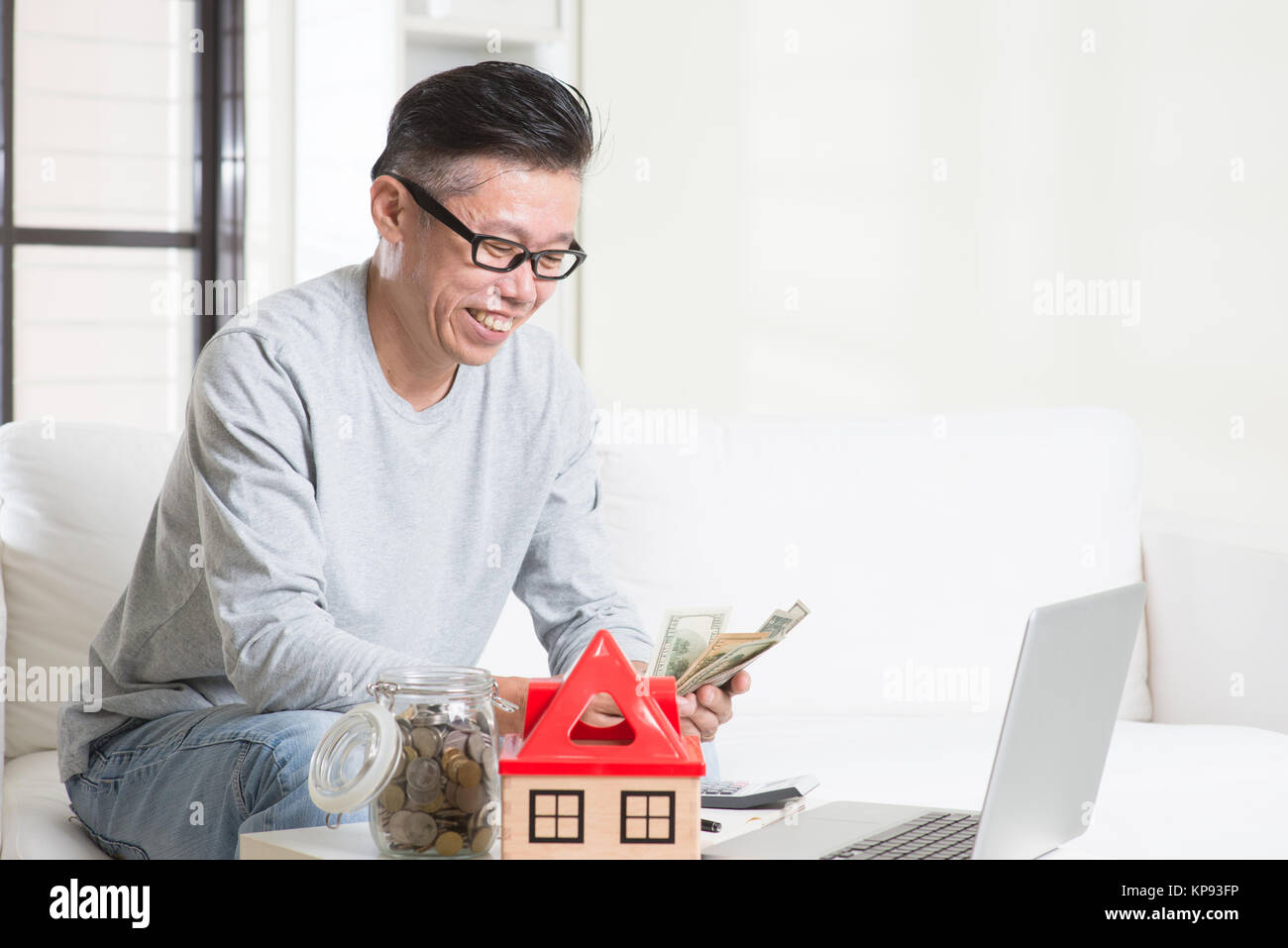 Mature Asian man counting on money Stock Photo - Alamy