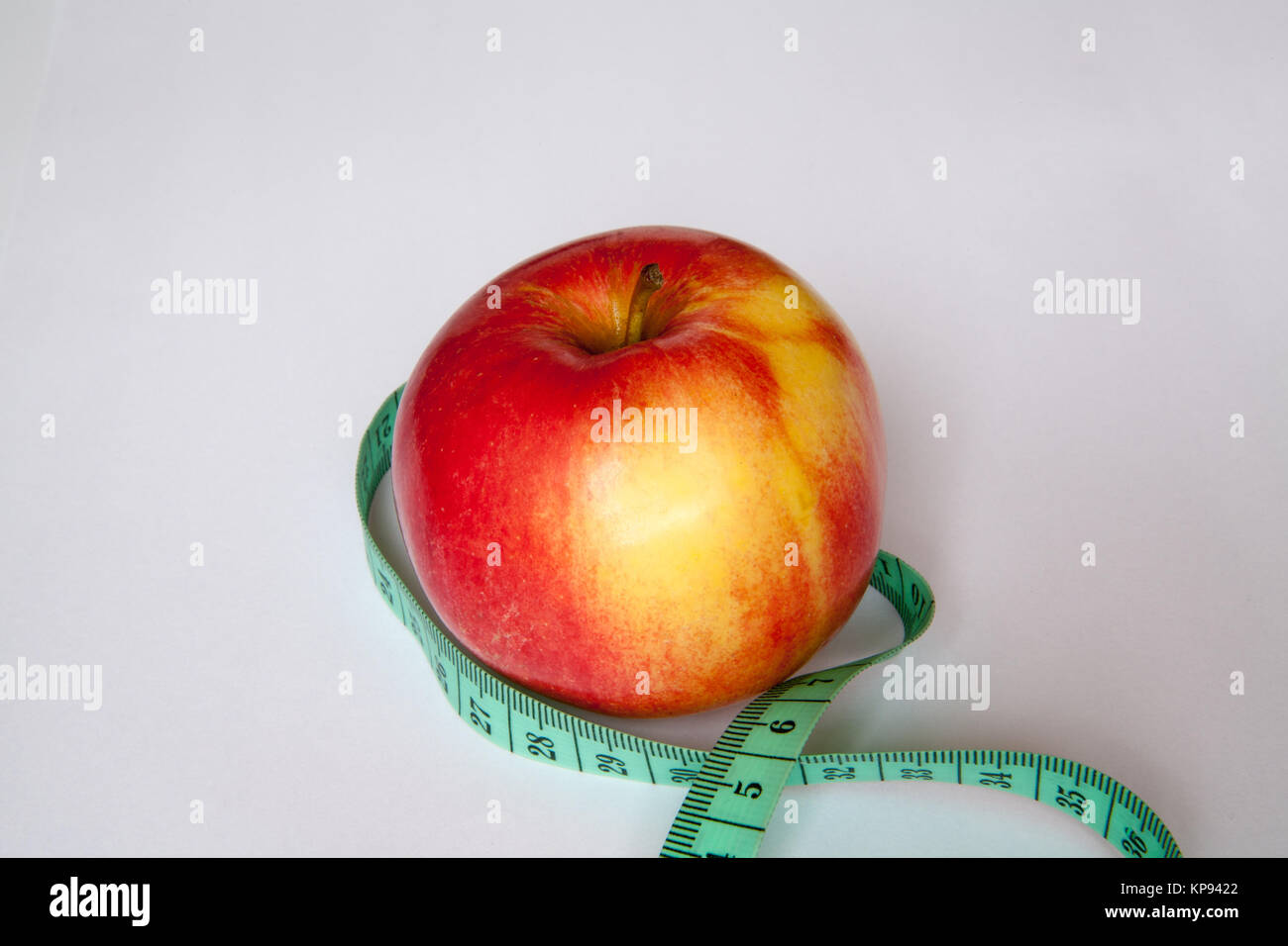 Apple and ruler are isolated on a white background Stock Photo - Alamy