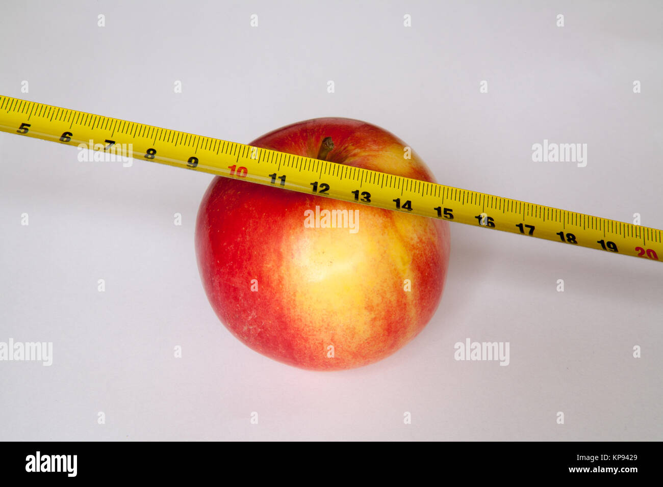 Apple and ruler are isolated on a white background Stock Photo - Alamy