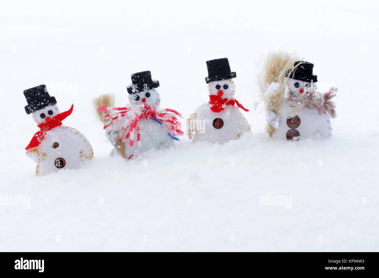 four snowmen in cold snow Stock Photo - Alamy