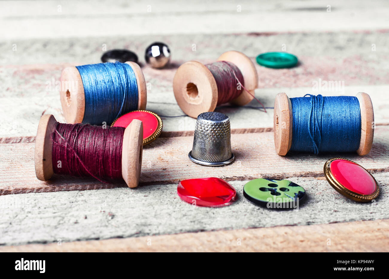 spools of thread and various buttons on wooden background Stock Photo ...