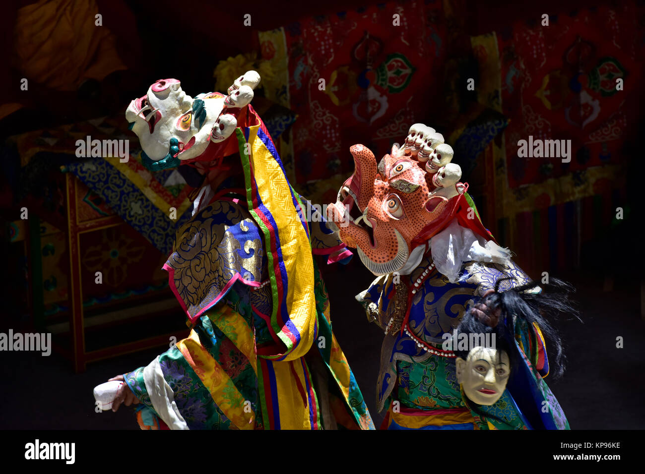 Two Buddhist lamas in the courtyard of the monastery in sacred masks of ...