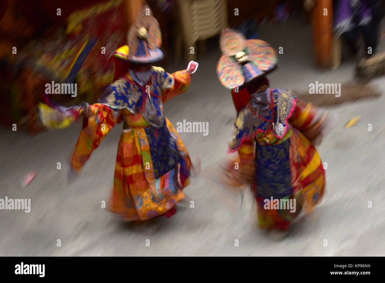 Two lamas in traditional bright sacred clothes and wide headdresses ...