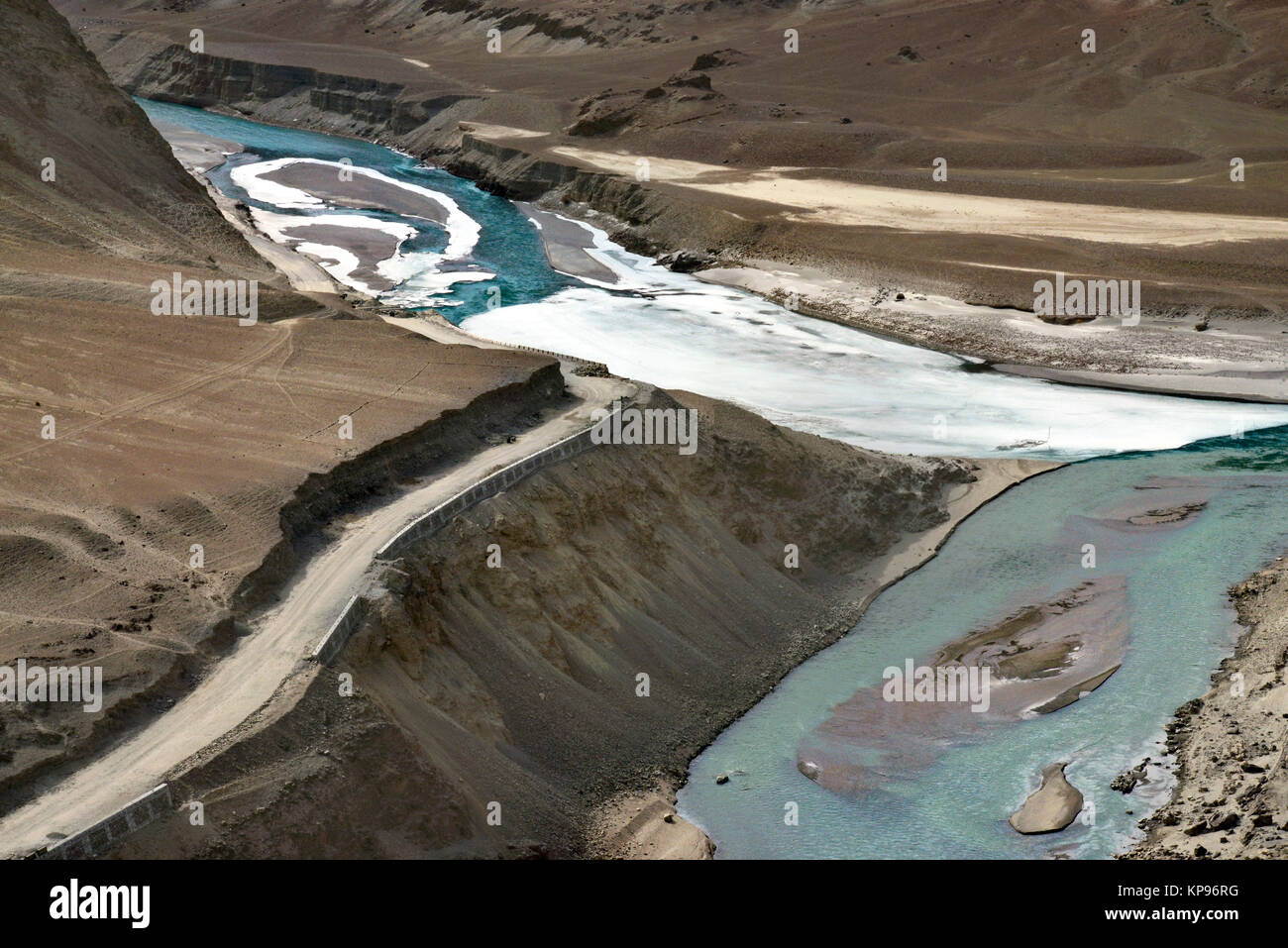 Confluence of the two mountain rivers in winter, the streams of blue ...